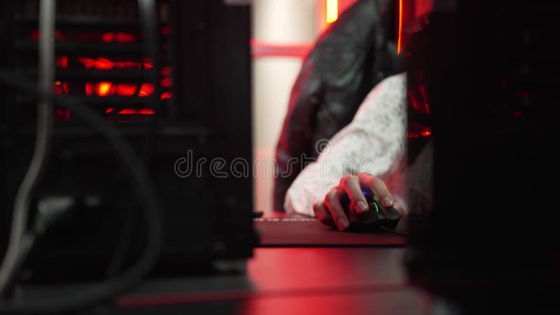 A Man with a Computer Mouse in His Hand in a Computer Club in a Dark ...