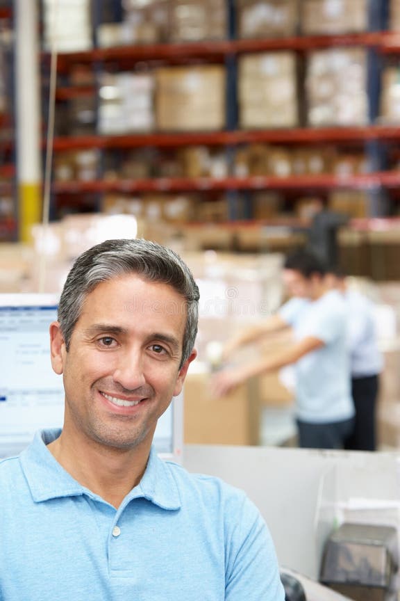 Man at Computer Terminal in Distribution Warehouse Stock Photo - Image ...