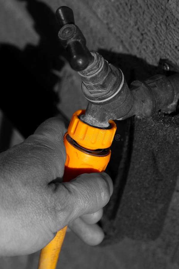 Man Connecting a Hose Pipe To an Outside Tap Stock Image - Image of ...