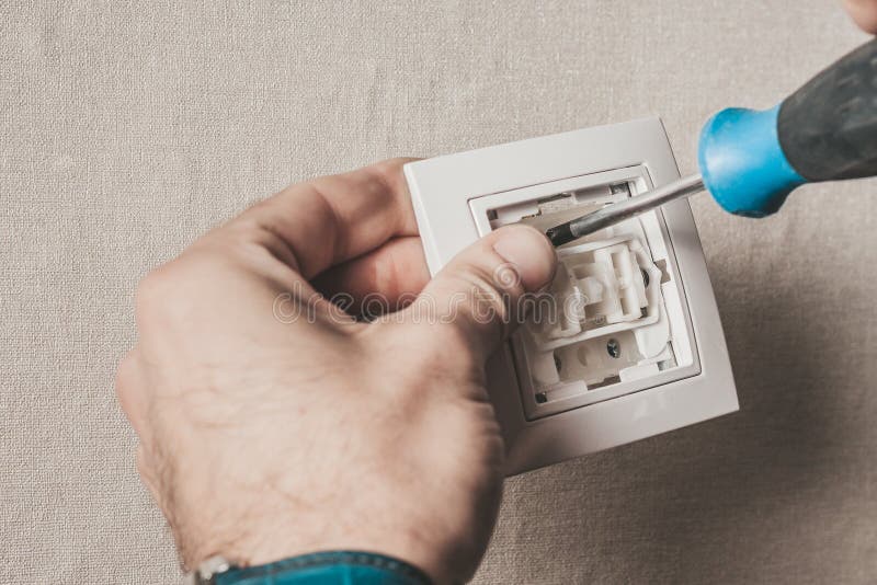 Man Connects an Electric Light Switch To the Wall Stock Photo - Image ...