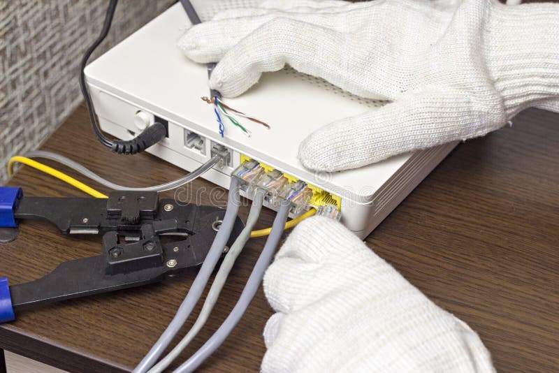 A Man Connects a Network Cable To the Modem, a Close-up Stock Image ...