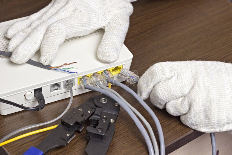 A Man Connects a Network Cable To the Modem, a Close-up Modem Stock ...
