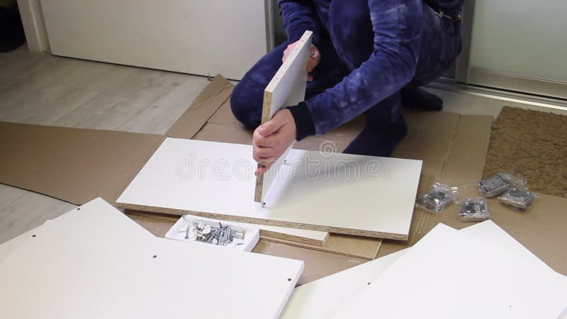 A Man Connects the Panels with an Eccentric. Wooden Modular Rack ...