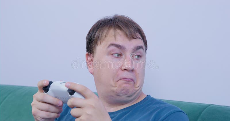 Man with Console Controller is Intently Playing Video Game. Something ...