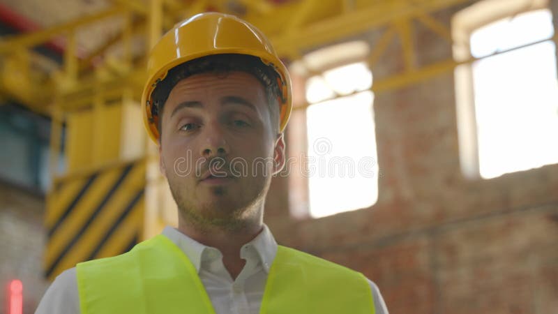 A Man in a Construction Vehicle and a Helmet on a Construction Site ...