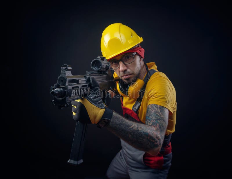 A Man in a Construction Worker`s Uniform Wearing a Hard Hat with an ...