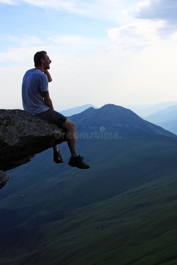 Man Contemplating on Top of a Rock Stock Photo - Image of outdoor ...