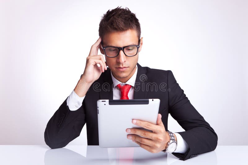 Man Contemplating at What he is Reading on Pad Stock Image - Image of ...