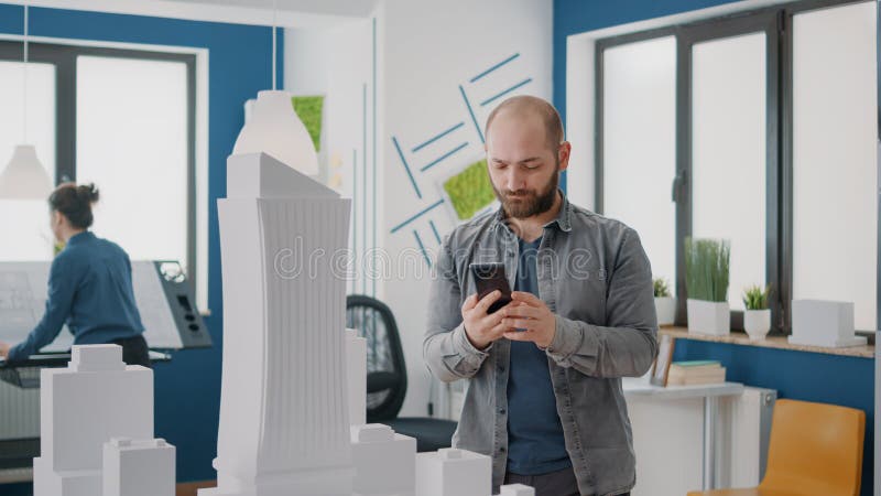 Man Contractor Using Mobile Phone To Design Building Model for ...