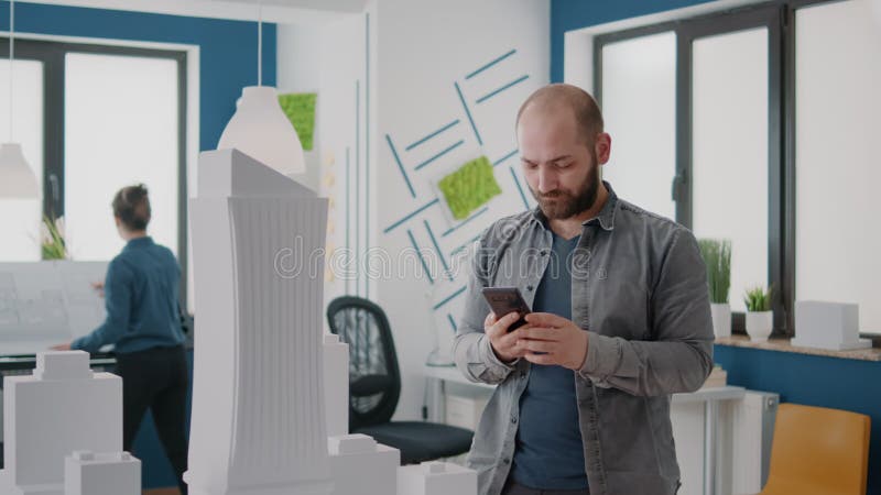 Man Contractor Using Mobile Phone To Design Building Model for ...
