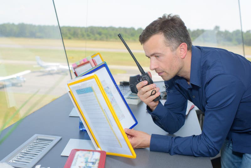 Man in Control Tower Talking into Two Way Radio Stock Photo - Image of ...