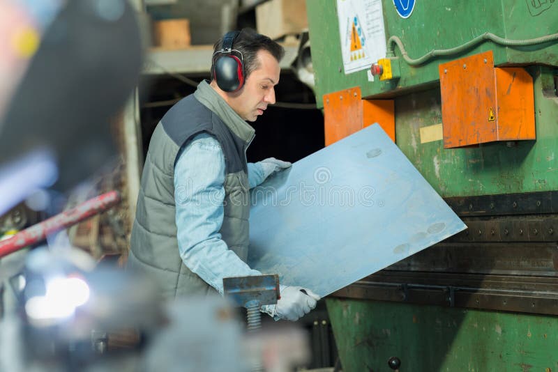 Man Controlling Hydraulic Press Machine for Cutting Steel Stock Photo ...
