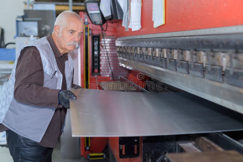 Man Controlling Hydraulic Press Machine for Cutting Steel Stock Photo ...