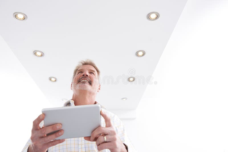 Man Controlling Lighting with App on Digital Tablet Stock Image - Image ...
