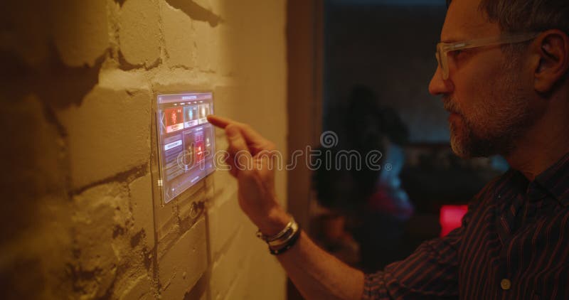 Man Controlling Lighting with Home Hub Stock Photo - Image of bedroom ...