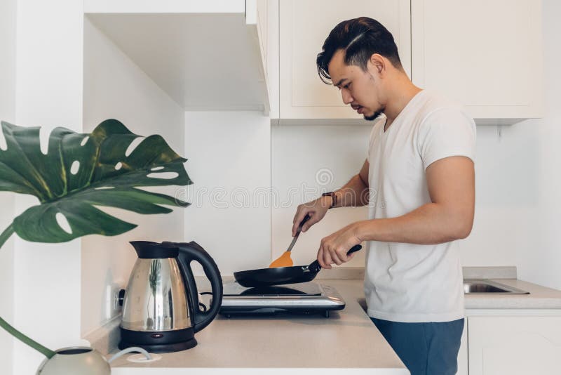 Man is Cooking Breakfast in the Kitchen. Stock Photo - Image of ...