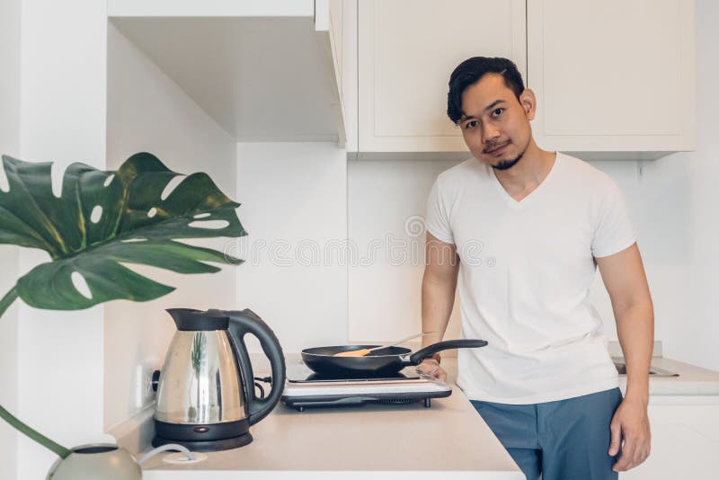 Man is Cooking Breakfast in the Kitchen. Stock Image - Image of ...
