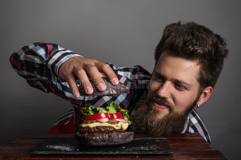 Man cooking burger stock image. Image of happy, fastfood - 117082975