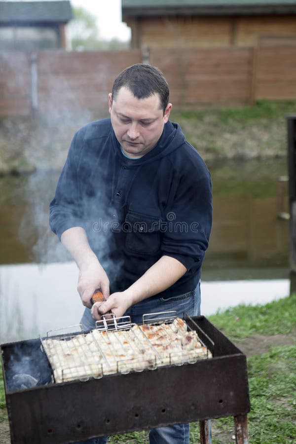Man cooking chicken stock image. Image of backyard, grilling - 70908711