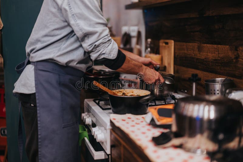 Man Cooking Dinner in a Cozy Rustic Kitchen Environment Stock Image ...