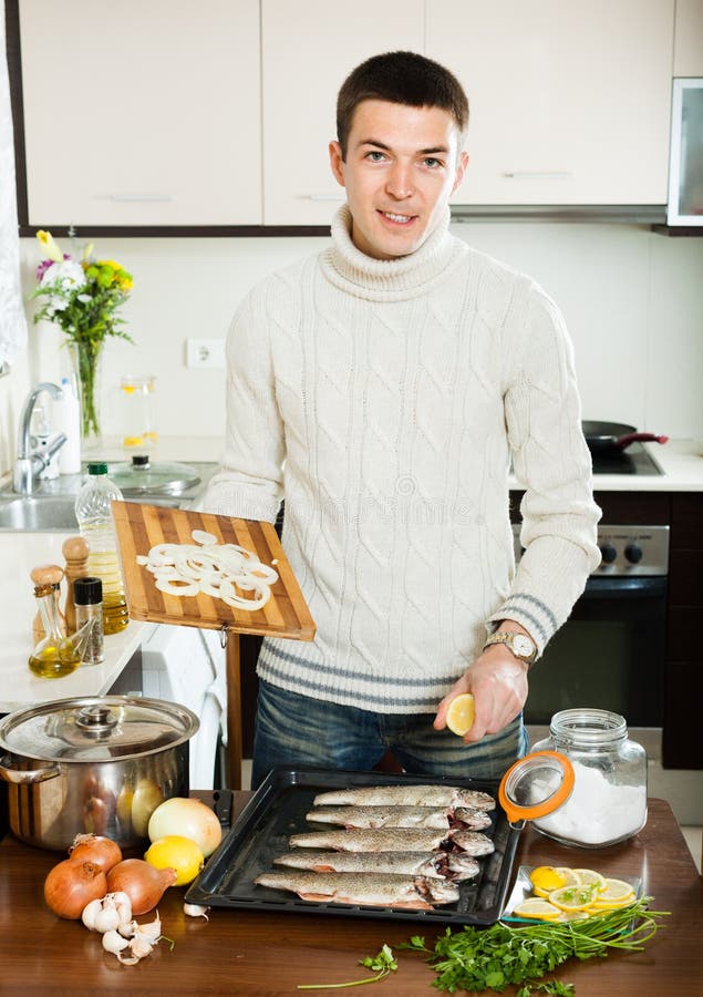 Man Cooking Fish in Baking Sheet at Home Stock Photo - Image of cooking ...
