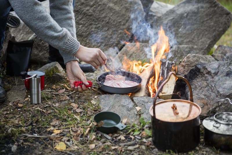 Man Cooking Food Over Bonfire at Campsite Stock Photo - Image of ...