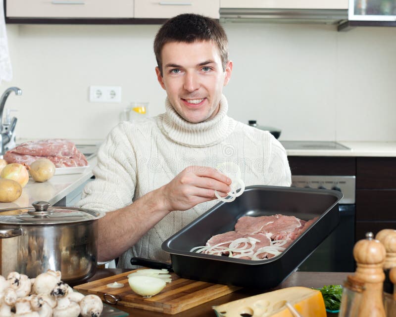 Man Cooking French-style Meat. Adding Onion in Roasting Pan Stock Image ...