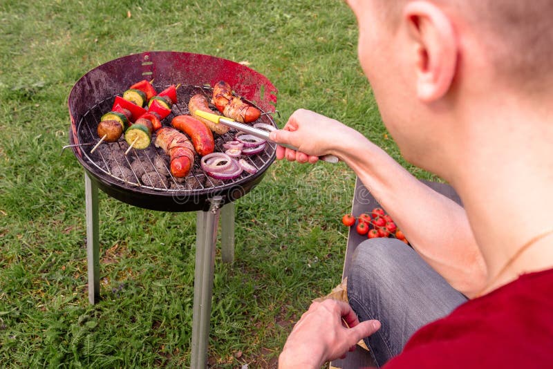 Man Cooking at Grill with Various Delicious Barbecue Outdoor, Selective ...