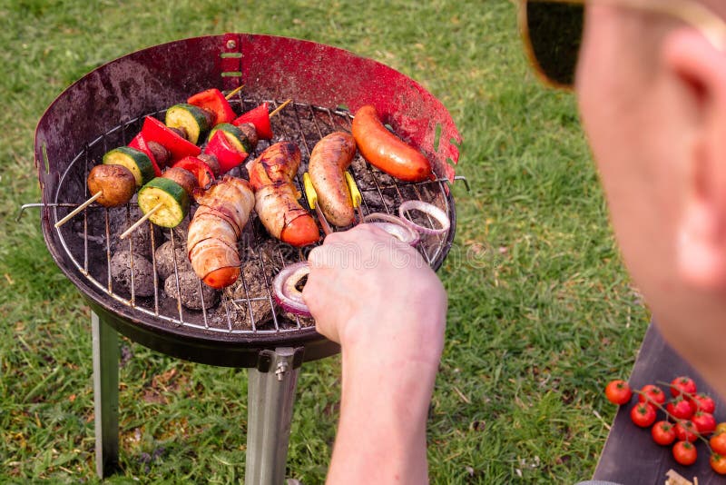 Man Cooking at Grill with Various Delicious Barbecue Outdoor, Selective ...