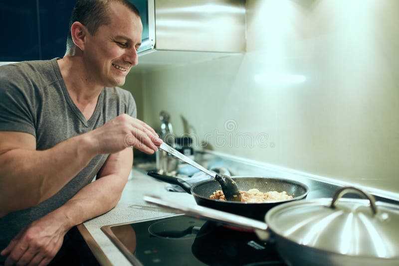 Man cooking at home alone stock photo. Image of enjoying - 68329458