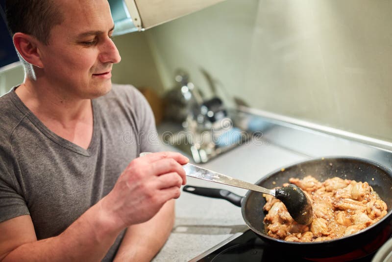 Man cooking at home alone stock image. Image of lifestyle - 68329461