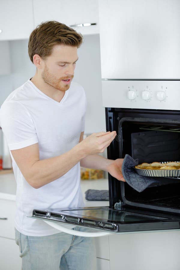 Man Cooking at Home Burns Fingers on Oven Stock Photo - Image of ...
