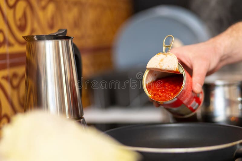 Man Cooking at Home Kitchenn Adding Sauce To Pan. Stock Photo - Image ...