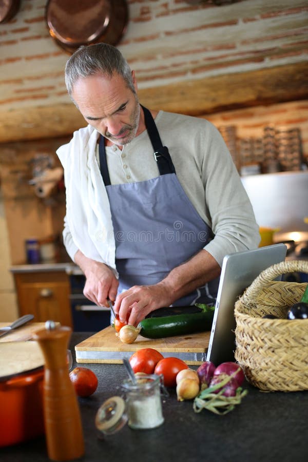 Man Cooking in Kitchen with Help of Tablet Stock Photo - Image of ...