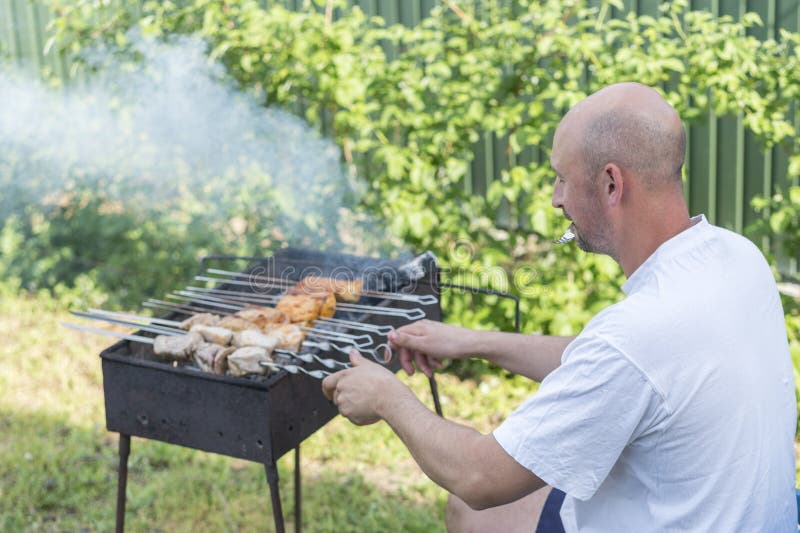 Man Cooking Meat on Barbecue Stock Image - Image of nature, leisure ...