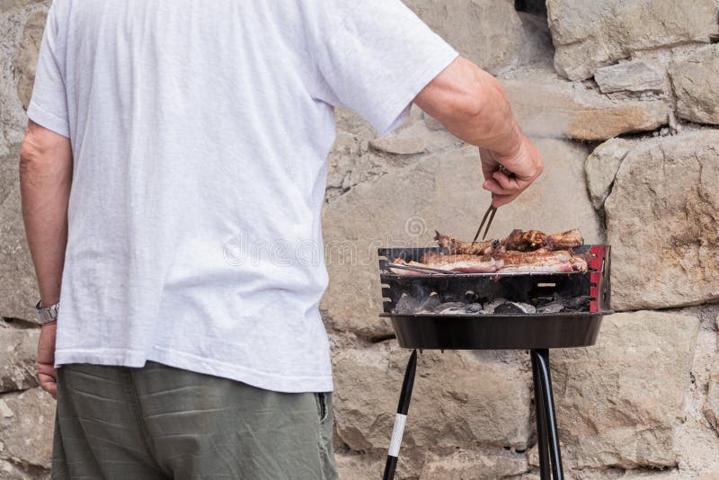 Man Cooking Meat on the Barbecue Stock Photo - Image of male, blaze ...