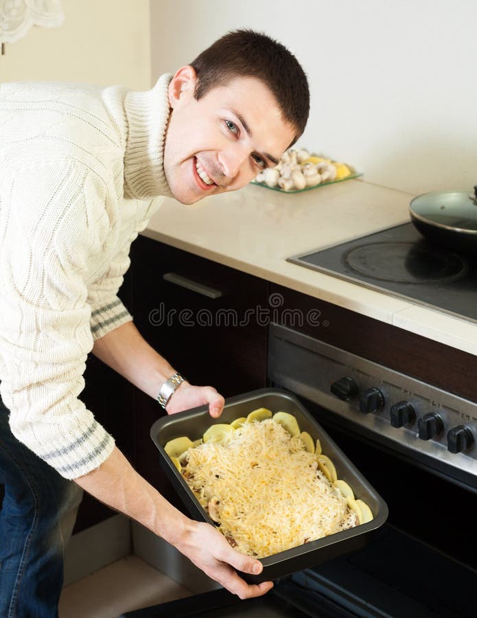 Man Cooking Meat with Cheese and Mushrooms at Home Stock Image - Image ...