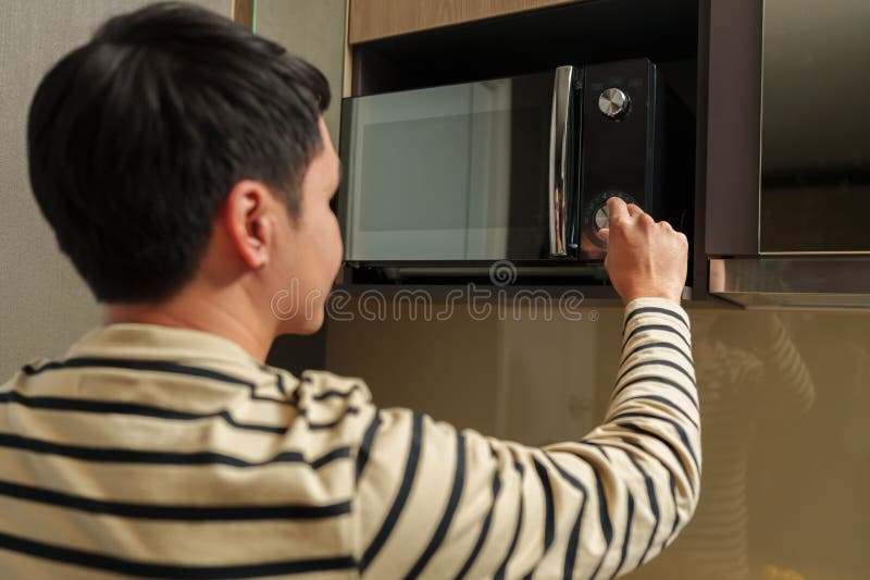 Man Cooking with a Microwave in Kitchen Room Stock Image - Image of ...