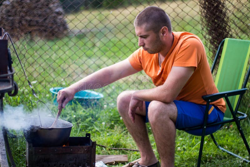 Man Cooking Outdoor on the Fire Stock Photo - Image of young, fire ...