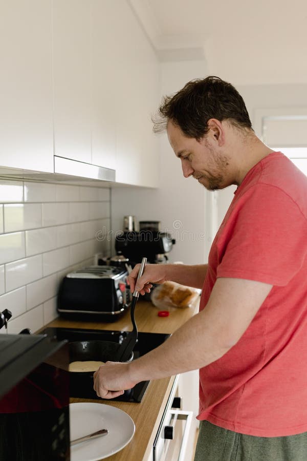A man cooking a pancake stock photo. Image of aged, ingredients - 255585980