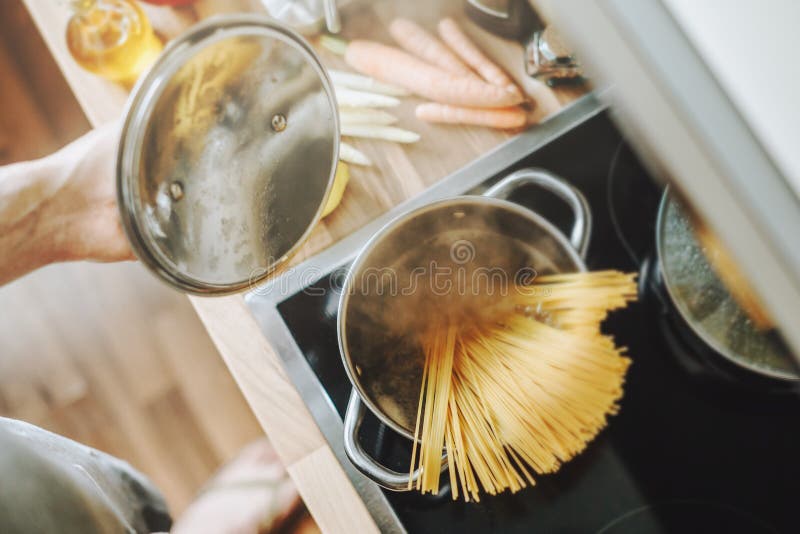 Man Cooking Pasta in the Kitchen Stock Photo - Image of dinner ...