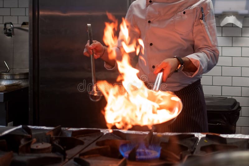 Flame in the Pan. Professional Chef Makes Flambe for Food in the ...