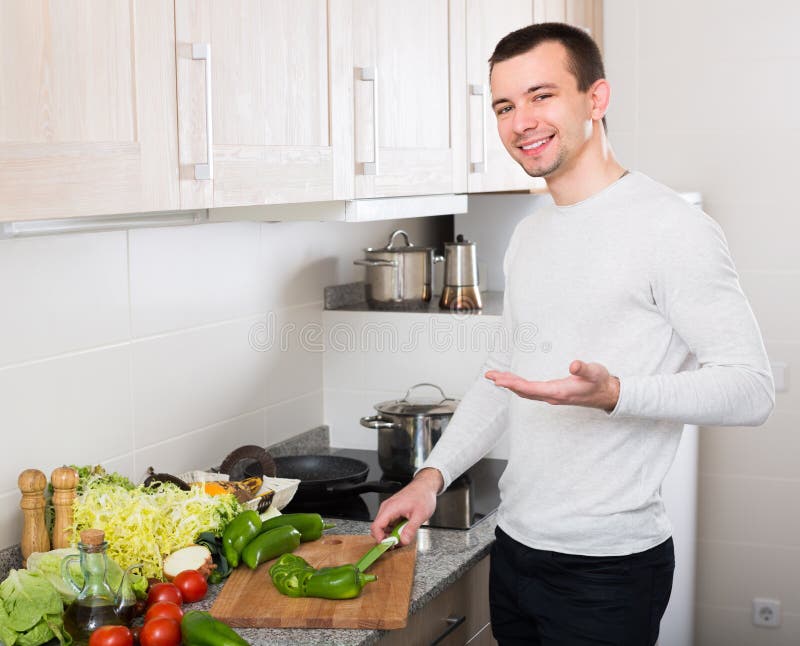 Man Cooks with Vegetables at Kitchen Stock Photo - Image of interior ...