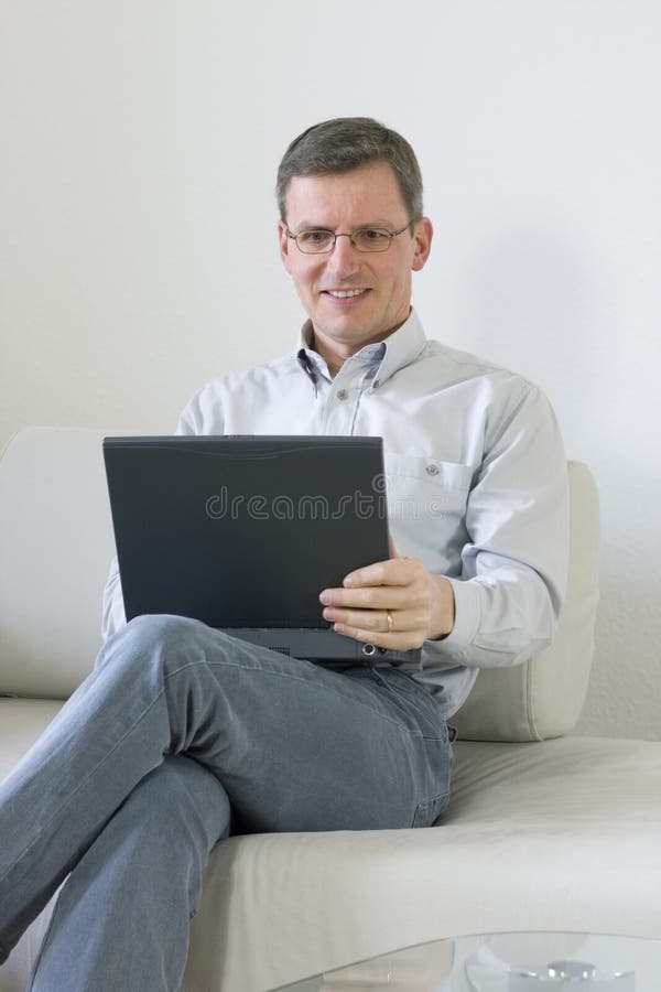 Man on Couch with Laptop Computer Stock Image - Image of play, aged ...