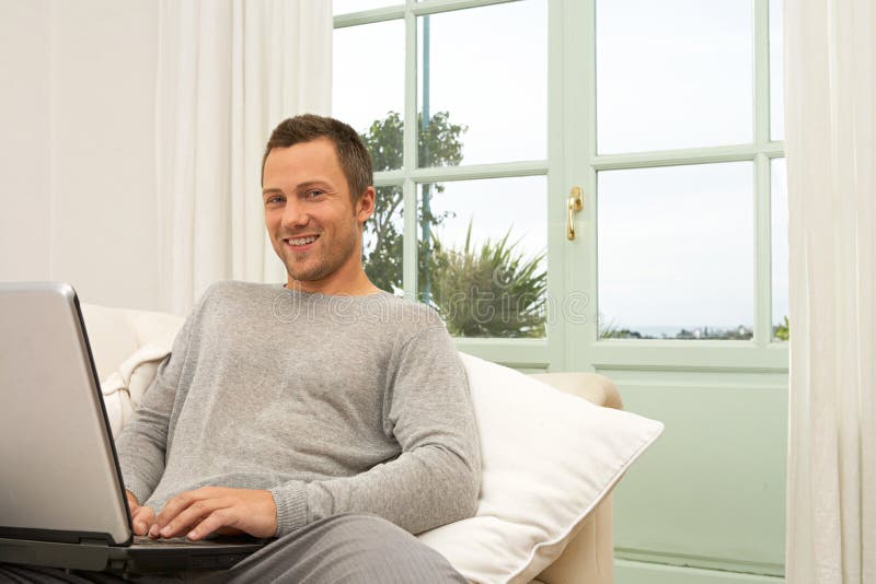 Man on Couch with Laptop at Home. Stock Photo - Image of house ...