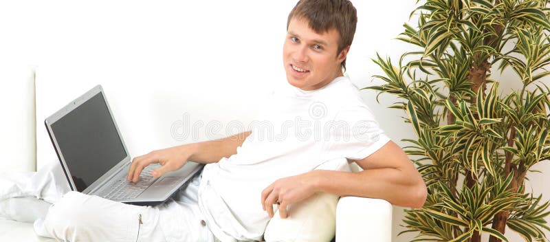 Very Focused Young Man Using Laptop while Sitting Comfortably. Stock ...