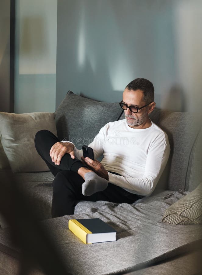 Man on Couch with Smartphone. Stock Image - Image of modern, adult ...