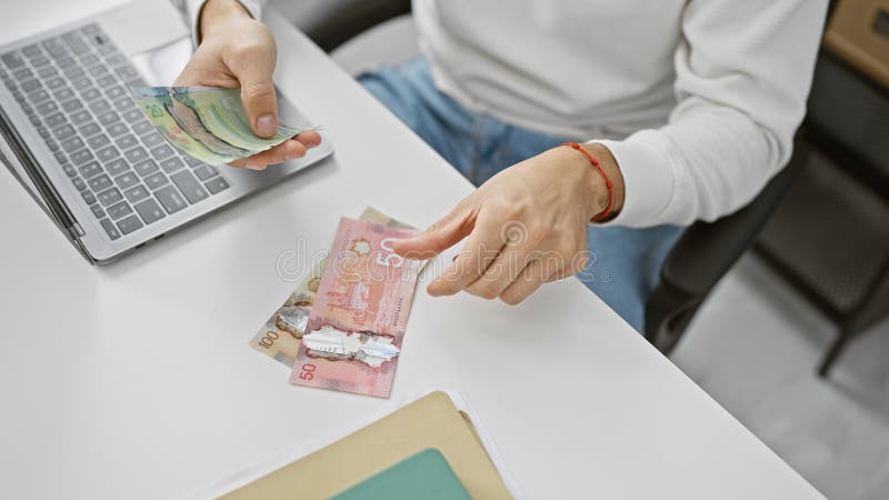 Man Counting Canadian Dollars at a Modern Office Desk, Showcasing ...