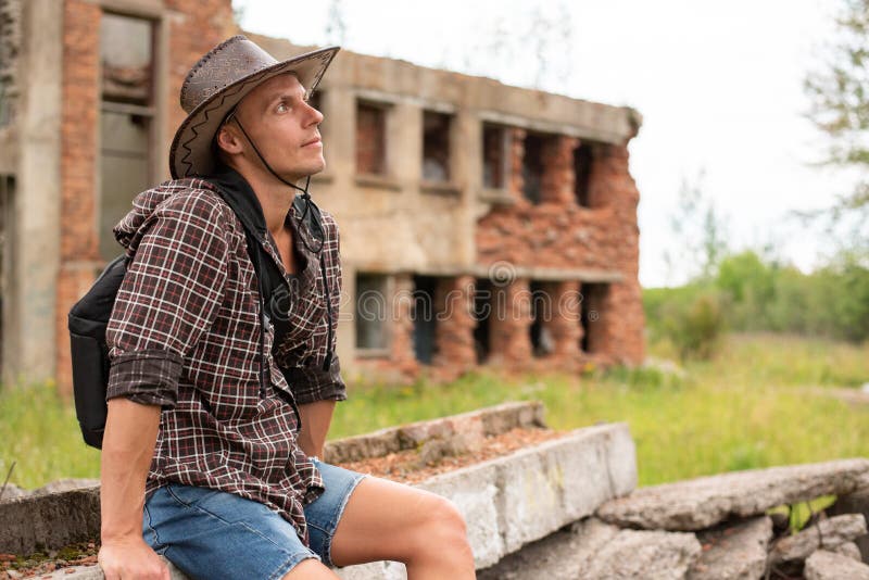 A Man in a Cowboy Hat Sits Amid a Ruined Home Stock Photo - Image of ...
