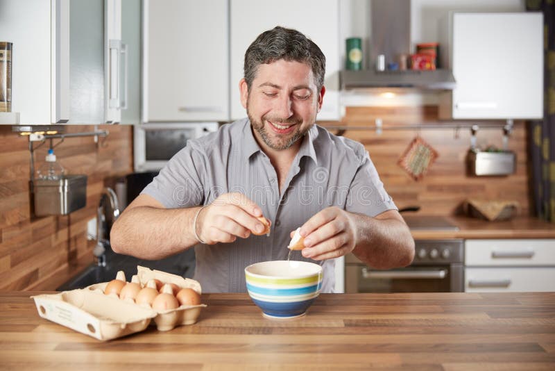 Man Cracking Egg in the Kitchen for Cooking Stock Image - Image of ...